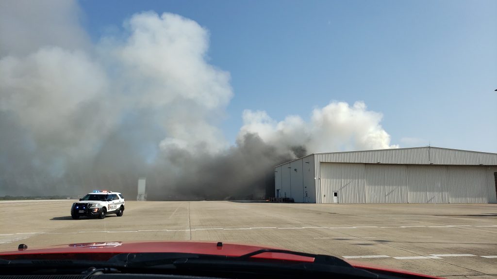 Firefighters battling a structure fire at Addison Airport | DFW Scanner