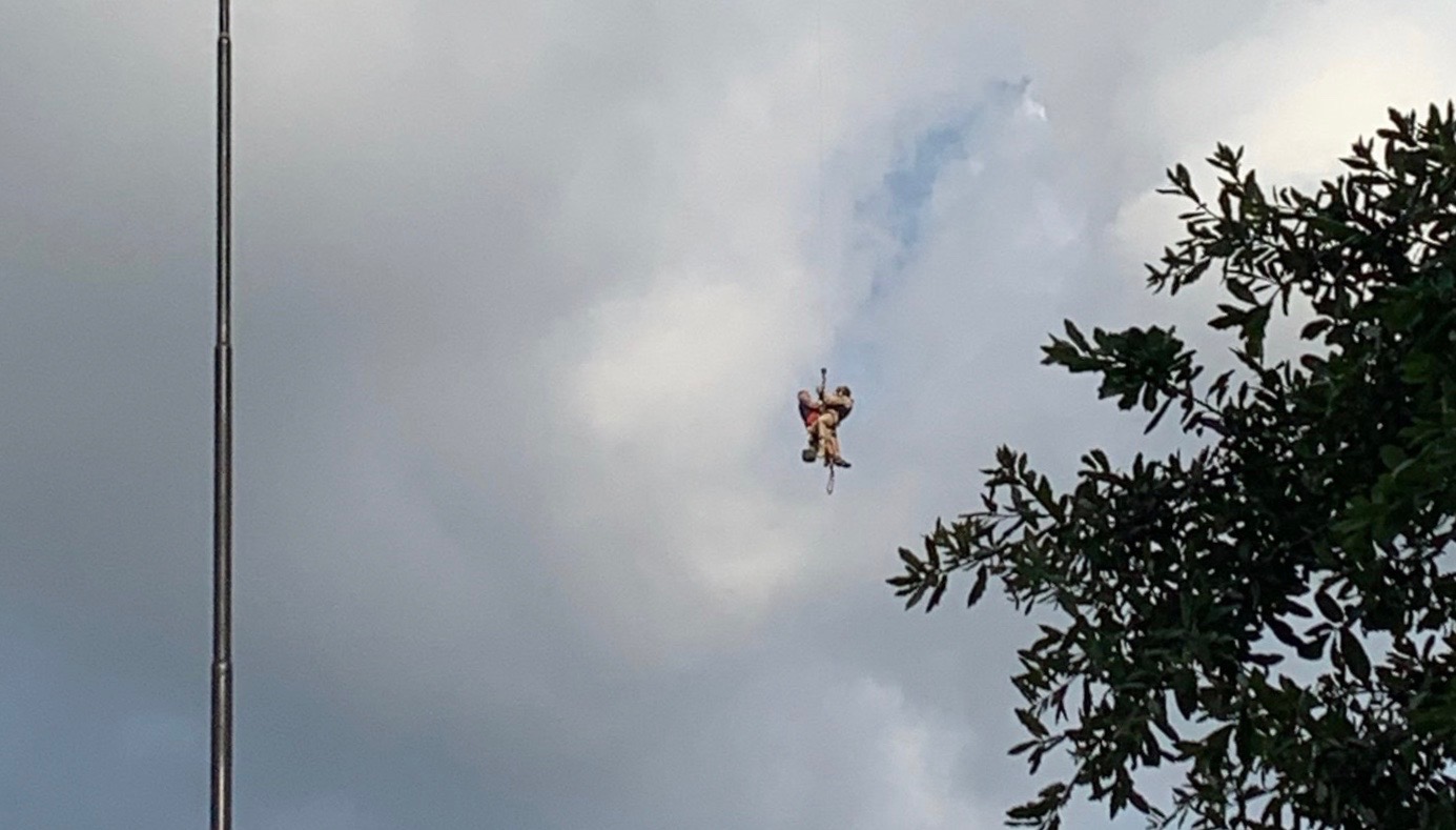 Flagpole maintenance man rescued after being trapped at top of pole for ...